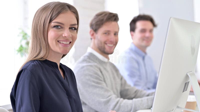 The Creative Team Using Laptop and Smiling at the Camera Stock Photo ...