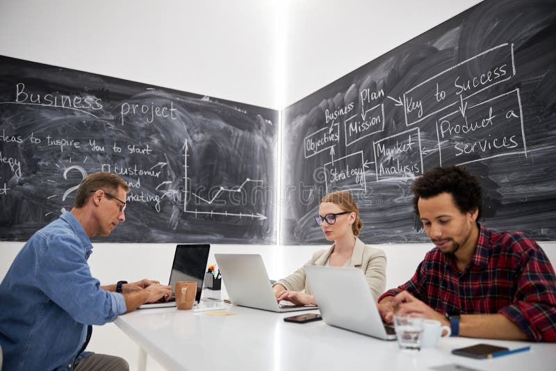 Creative Team Using Laptops while Working on New Project Stock Image ...