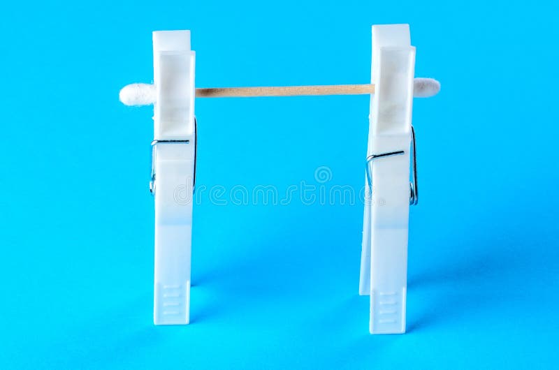 Creative Use of Clothespins and a Wooden Stick for a DIY Project on a Vibrant Blue Background ...