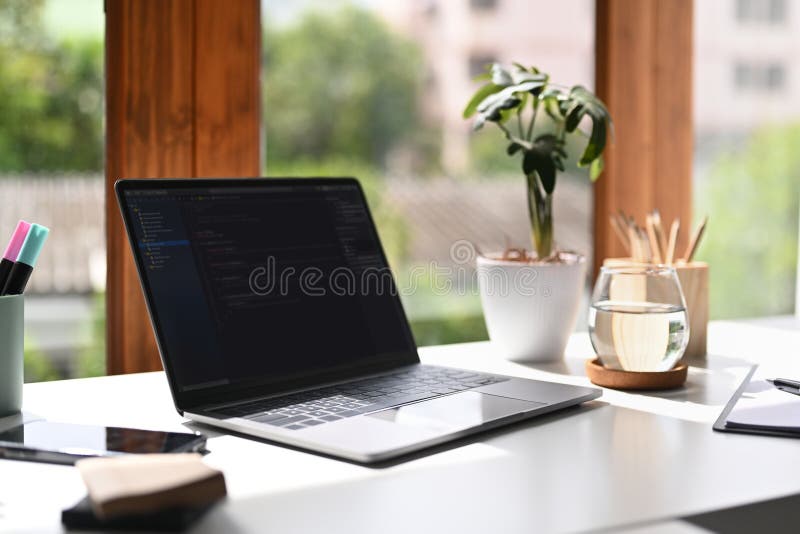 Creative Workplace with Laptop Computer, Potted Plant and Stationery on ...