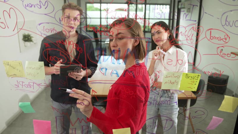 Team Brainstorming Marketing Idea while Manager Standing at Board ... Team Brainstorming Marketing Idea while Manager Standing at Board ...
