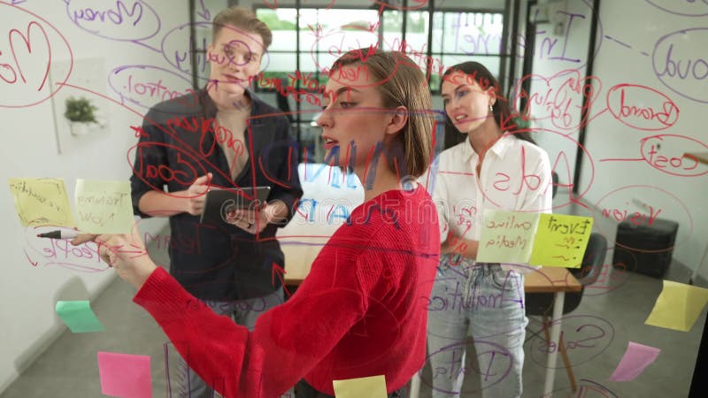 Team Brainstorming Marketing Idea while Manager Standing at Board ... Team Brainstorming Marketing Idea while Manager Standing at Board ...