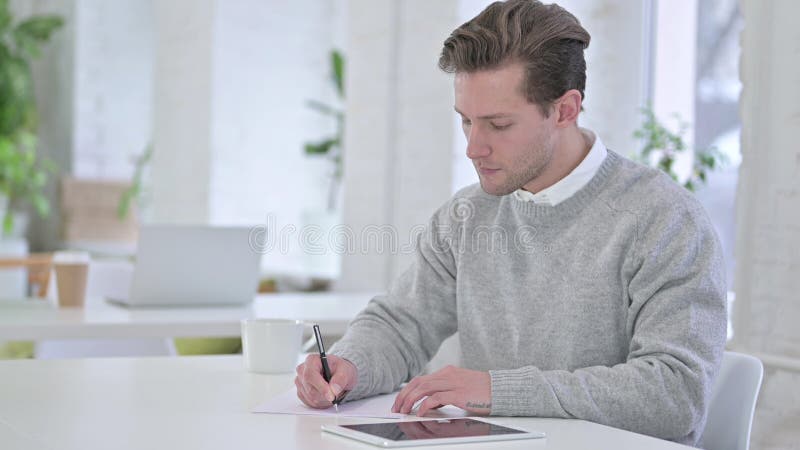 Creative Young Man Doing Paperwork in Loft Office Stock Photo - Image ...