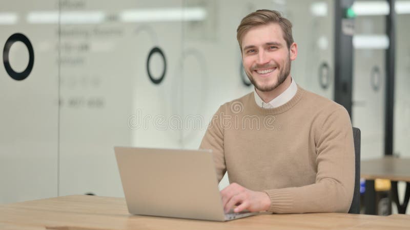 Young Man with Laptop Smiling at the Camera Stock Photo - Image of ...