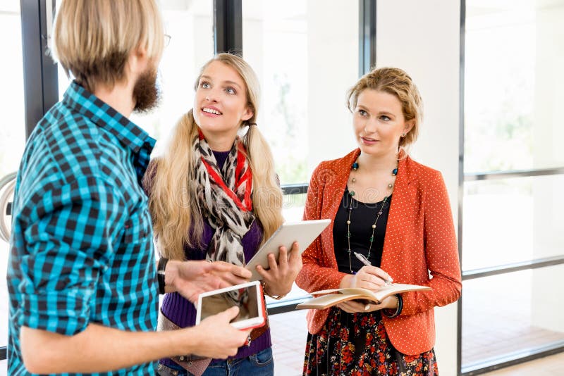 Young Office Workers Discussing Stock Photo - Image of caucasian ...