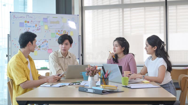 Creative People Sitting Around the Table and Working in Team at Start ...