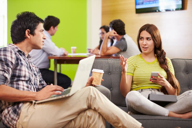 Creatives Having Informal Meeting on Sofas in Design Studio Stock Image ...