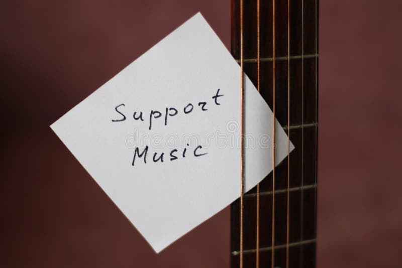 Support Music Note Attached To Acoustic Guitar Stock Photo - Image of ...
