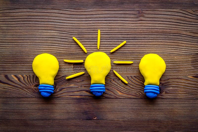 Creativity Concept. Bulb Icons on Dark Wooden Background Top-down Stock ...