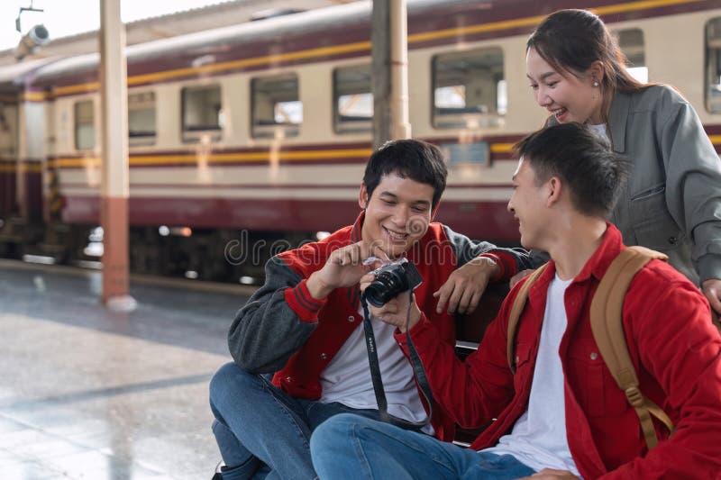 Creativity and Connection. Friends Gather Around a Camera, Sharing ...