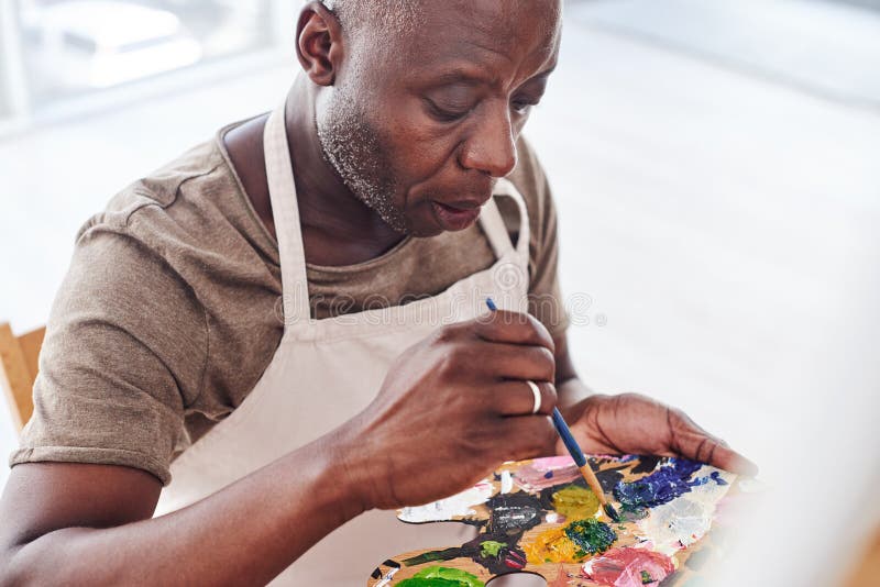 Creativity Takes Courage. a Middle Aged Man Painting in a Art Studio ...