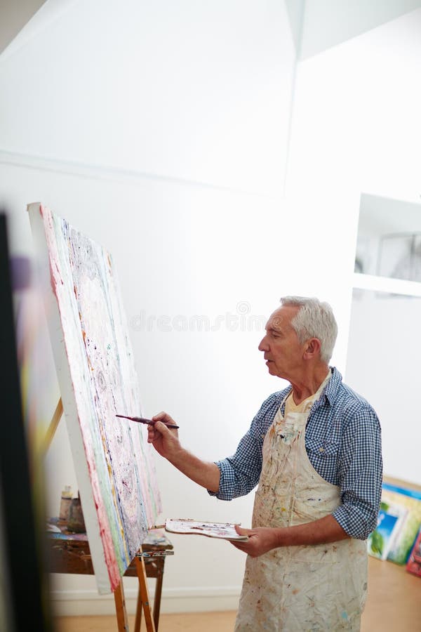 Creativity is a Wild Mind and a Focused Eye. a Senior Man Working on a ...