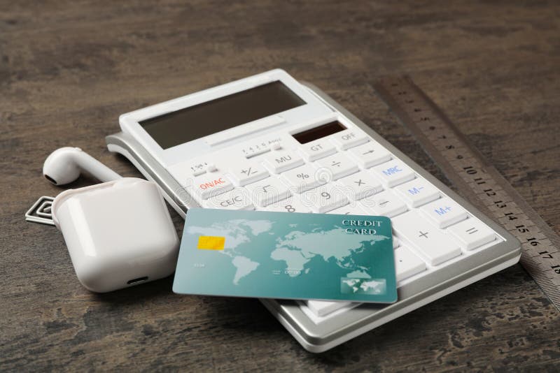 Credit Card, Calculator and Wireless Earphones on Table Stock Photo ...