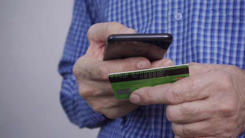 Closeup of Man Hands Holding Credit Card and Using Smartphone ...