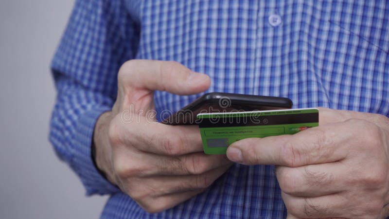 Closeup of Man Hands Holding Credit Card and Using Smartphone ...
