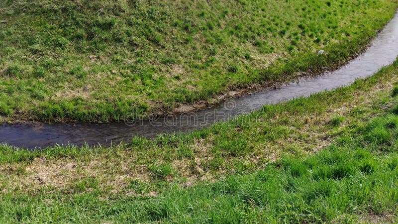 Creek or Small River Flows through a Meadow and Hill Stock Photo ...