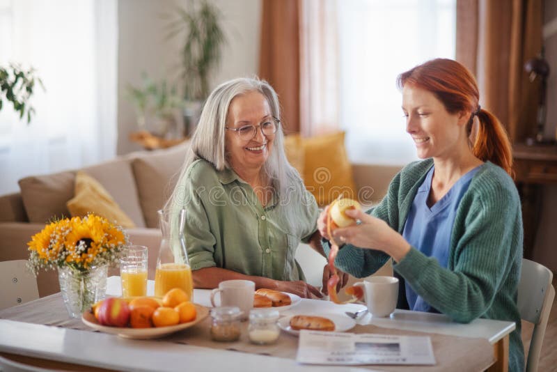 Cregiver Preparing Breakfast for Her Senior Client in the Bed. Stock ...