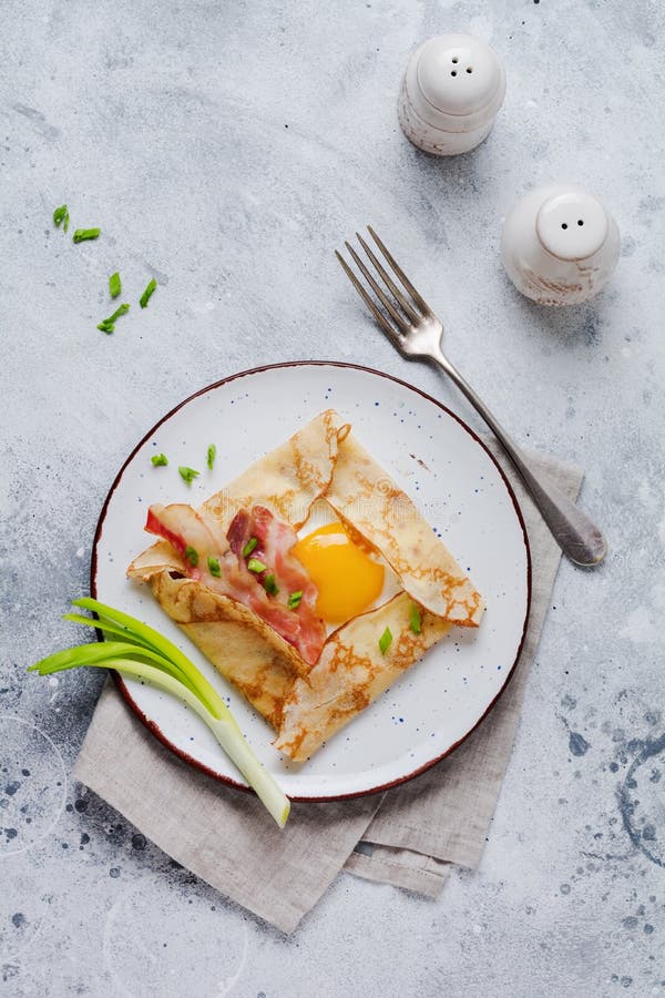 Crepe with Fried Egg, Cheese, Bacon and Green Onions for Breakfast on a ...