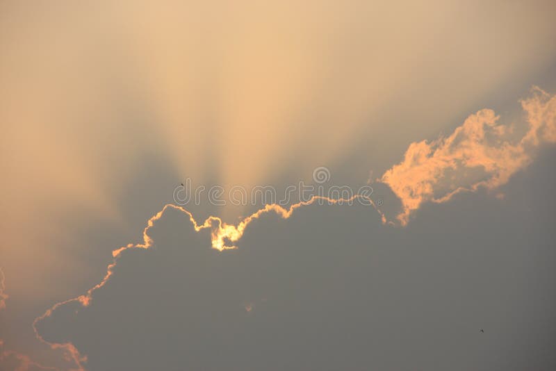 Sun rays behind clouds stock image. Image of storm, light - 1167285