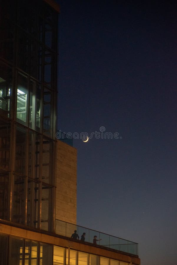 Crescent Moon in the Night Sky Next To a Building Stock Photo - Image ...