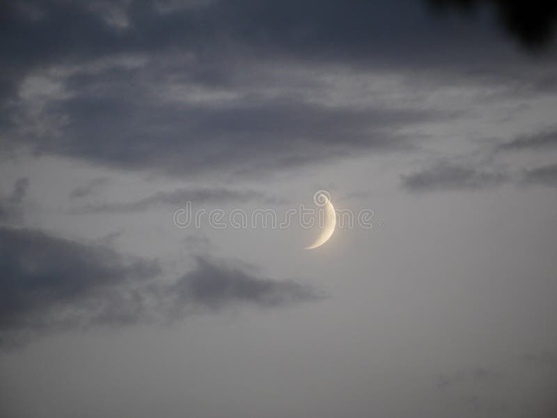 A Crescent Moon is Shining Brightly in the Sky Stock Photo - Image of ...