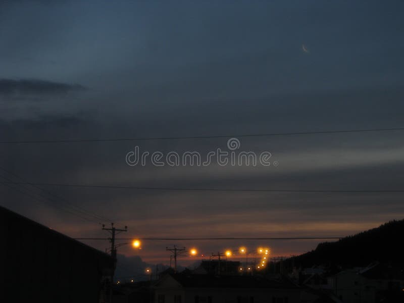 Crescent Moon in Twilight Sky Stock Photo - Image of street, foggy ...