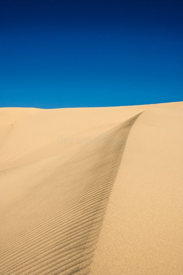 Crest of a Dune is Highlighted by Desert Dust on the Left Side of the ...