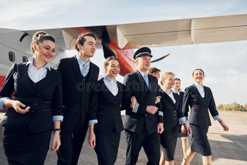Pilot and Two Stewardesses. Crew of Airport and Plane Workers in Formal ...