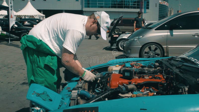 Crew of Mechanics Test the Engine of a Racing Car before the ...