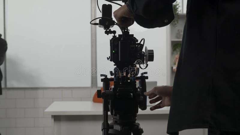 Crew Preparing for Shoot in Studio. the Videographer Mounts the Camera ...