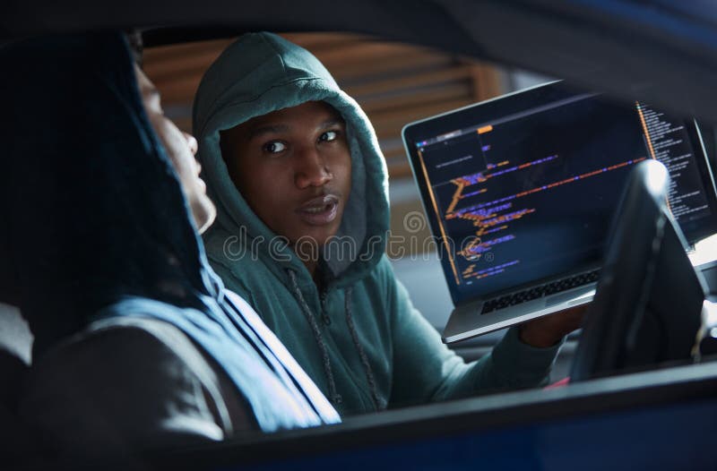 Crime is Everywhere. Two Young Hackers Using a Laptop in a Car. Stock ...