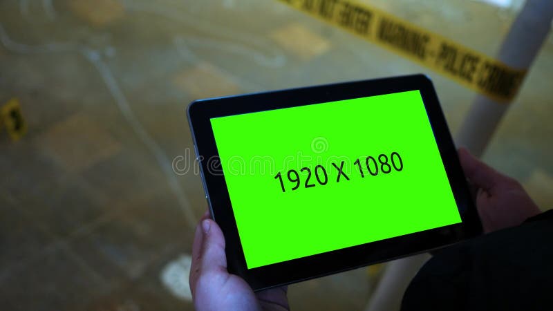 Crime Scene Investigator Holding an Tablet with Green Screen at an ...