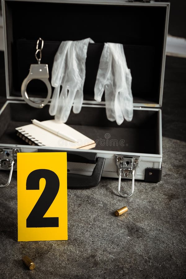 Shell Casings and Evidence Marker on Black Slate Table, Closeup. Crime ...