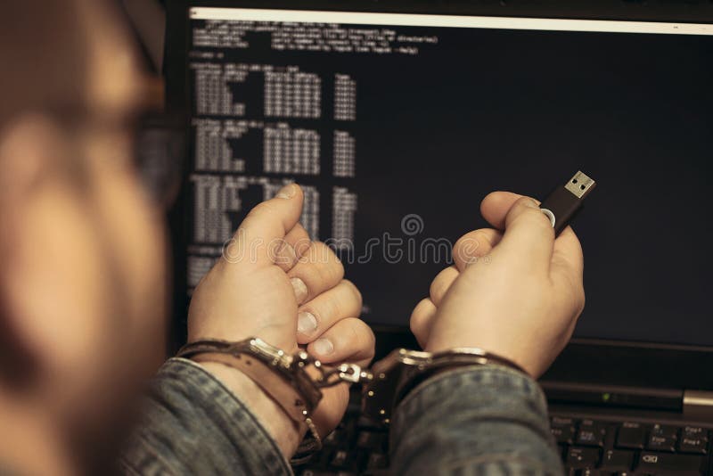 Criminal Hacker Hands Locked in Handcuffs. Close-up View Stock Photo ...
