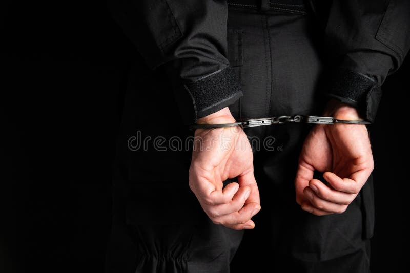 Criminal Hands Locked in Handcuffs. Close-up View Stock Image - Image ...