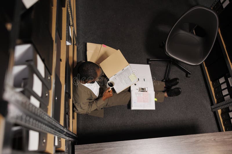 Criminologist Drinking Coffee and Reading Crime Case on Floor Stock ...