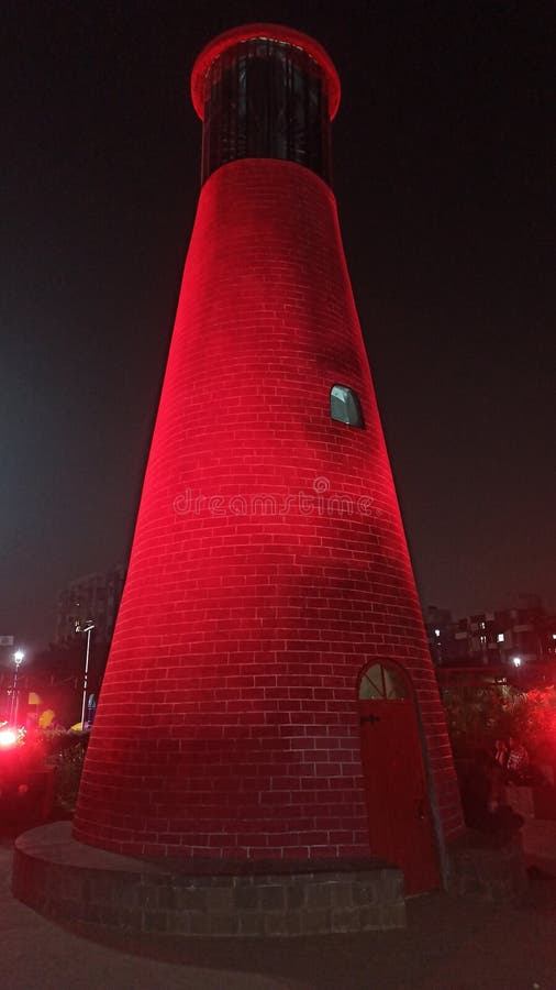 Crimson Sentinel: Lighthouse Illuminated at Night Stock Image - Image ...