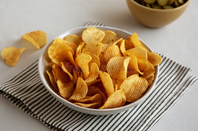 Crinkle Potato Chips and Green Pickle Chips in Bowls, Side View Stock ...