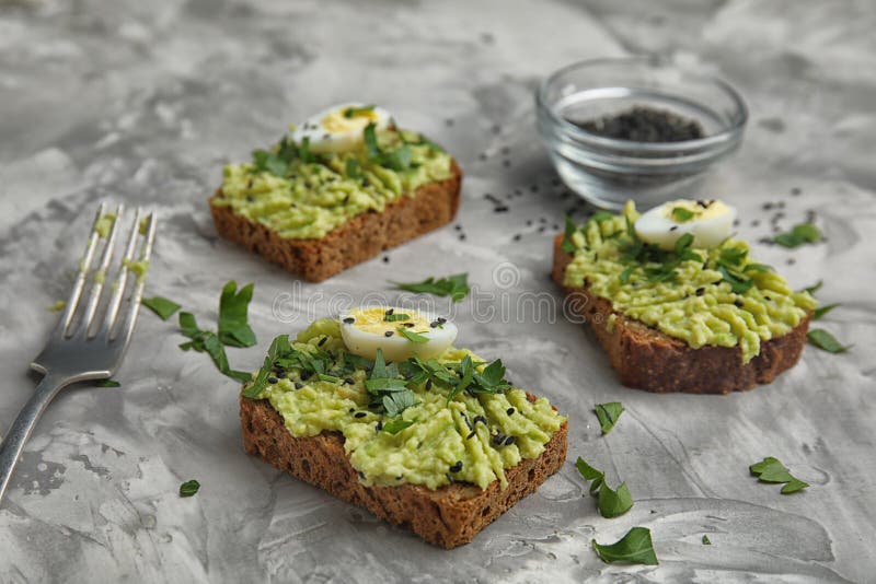 Crisp Rye Toasts with Avocado and Quail Eggs Stock Photo - Image of ...