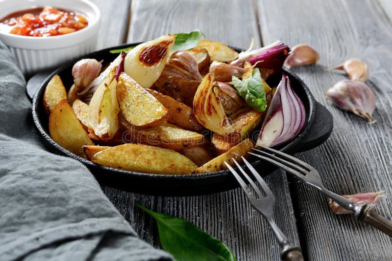 Crispy Baked Potatoes with Basil Stock Photo - Image of sauce, pieces ...