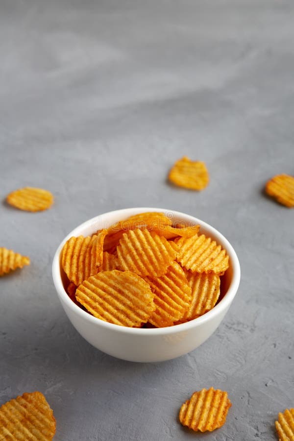 Crispy Barbeque Potato Chips in a Bowl on a Gray Surface, Side View ...
