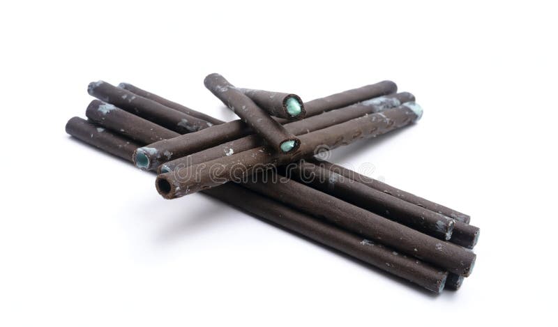 Crispy Biscuit Rolls with Black Bars Filled with Green Cream on a White ...