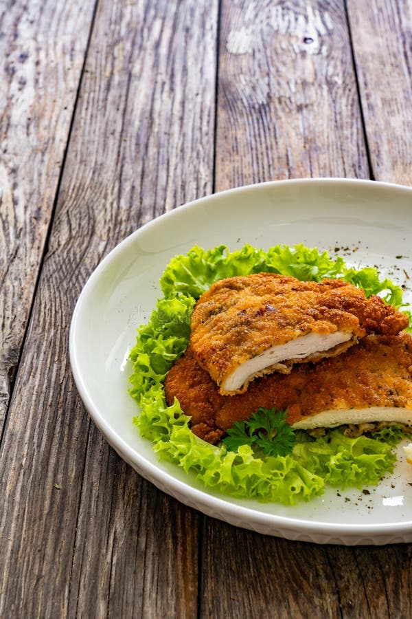 Crispy Breaded Seared Chicken Cutlet with Lemon Slices and Fresh ...