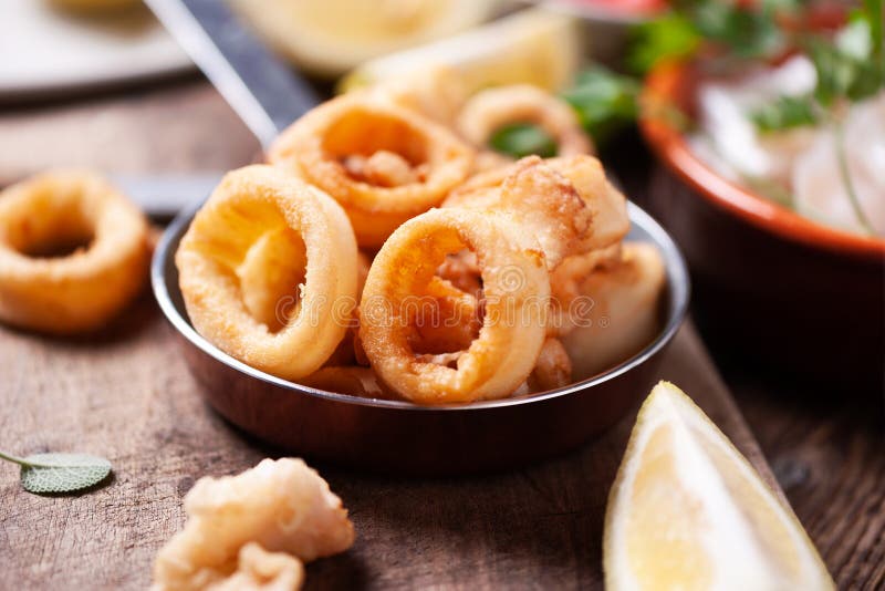 Crispy Calamari Rings on a Rustic Table Stock Image - Image of board ...