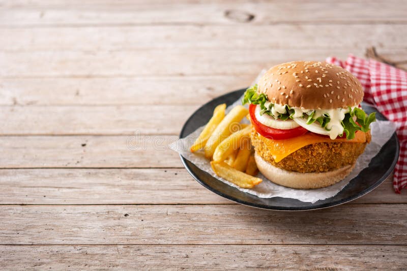 Crispy Chicken Burger with Cheese on Wooden Table Stock Photo - Image ...