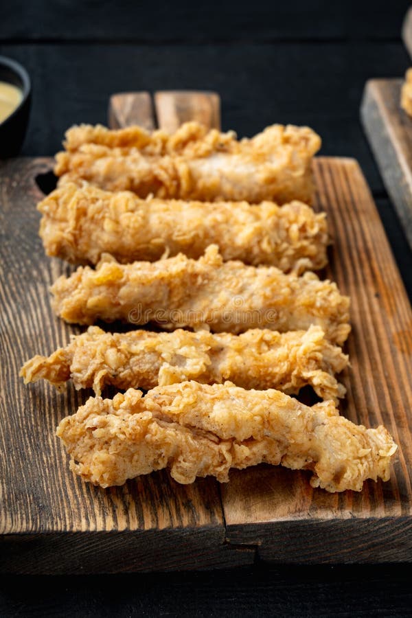 Crispy Chicken Sticks On Black Wooden Background Stock Image - Image of ...