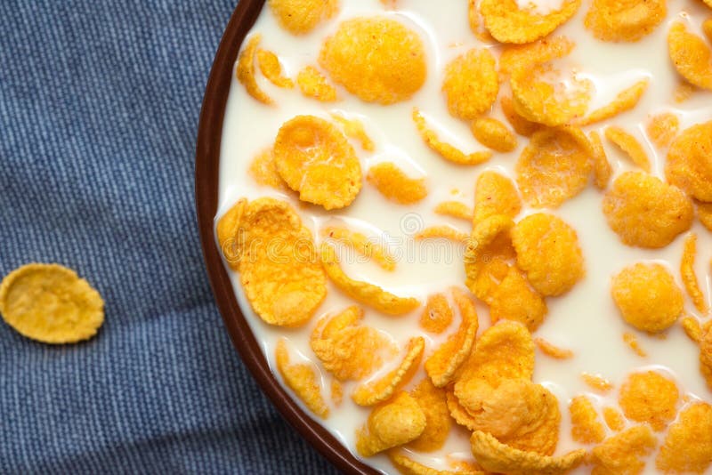 Crispy Corn Flakes with Milk on a Blue Table. Top View Stock Photo ...