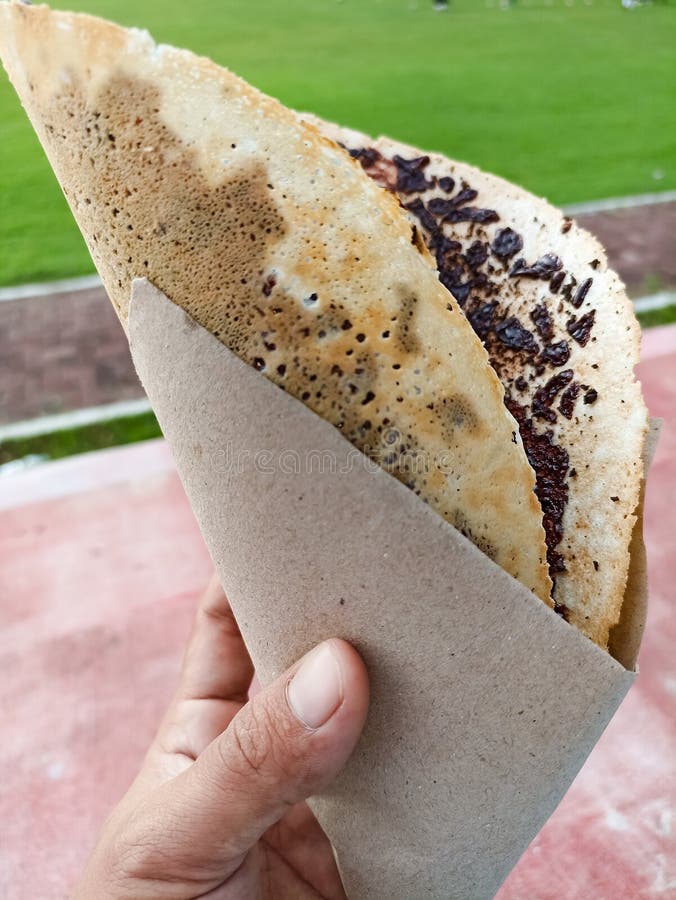 Crispy Crepes Cake with Chocolate Sprinkles. in Hand Stock Photo ...
