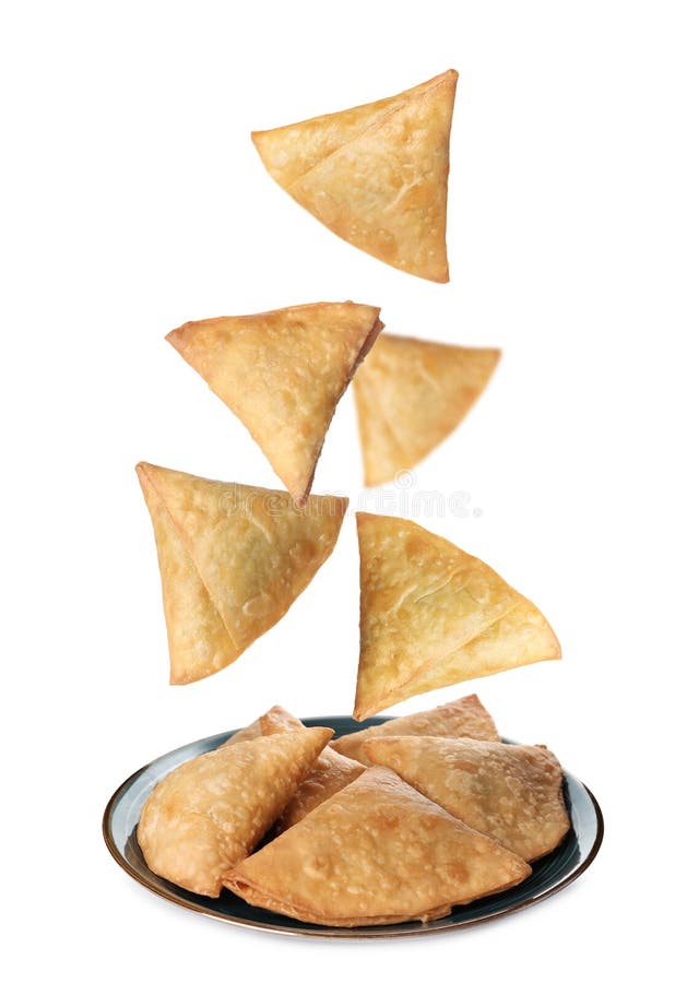 Crispy Delicious Samosas Falling into Plate on White Background Stock ...