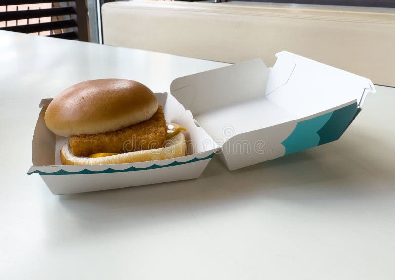 Crispy Fish Sandwich with Cheese in Open Cardboard Box on Light Surface ...